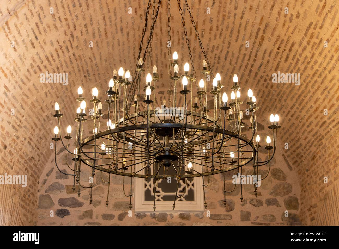 Old iron chandelier on the ceiling of a stone building Stock Photo - Alamy