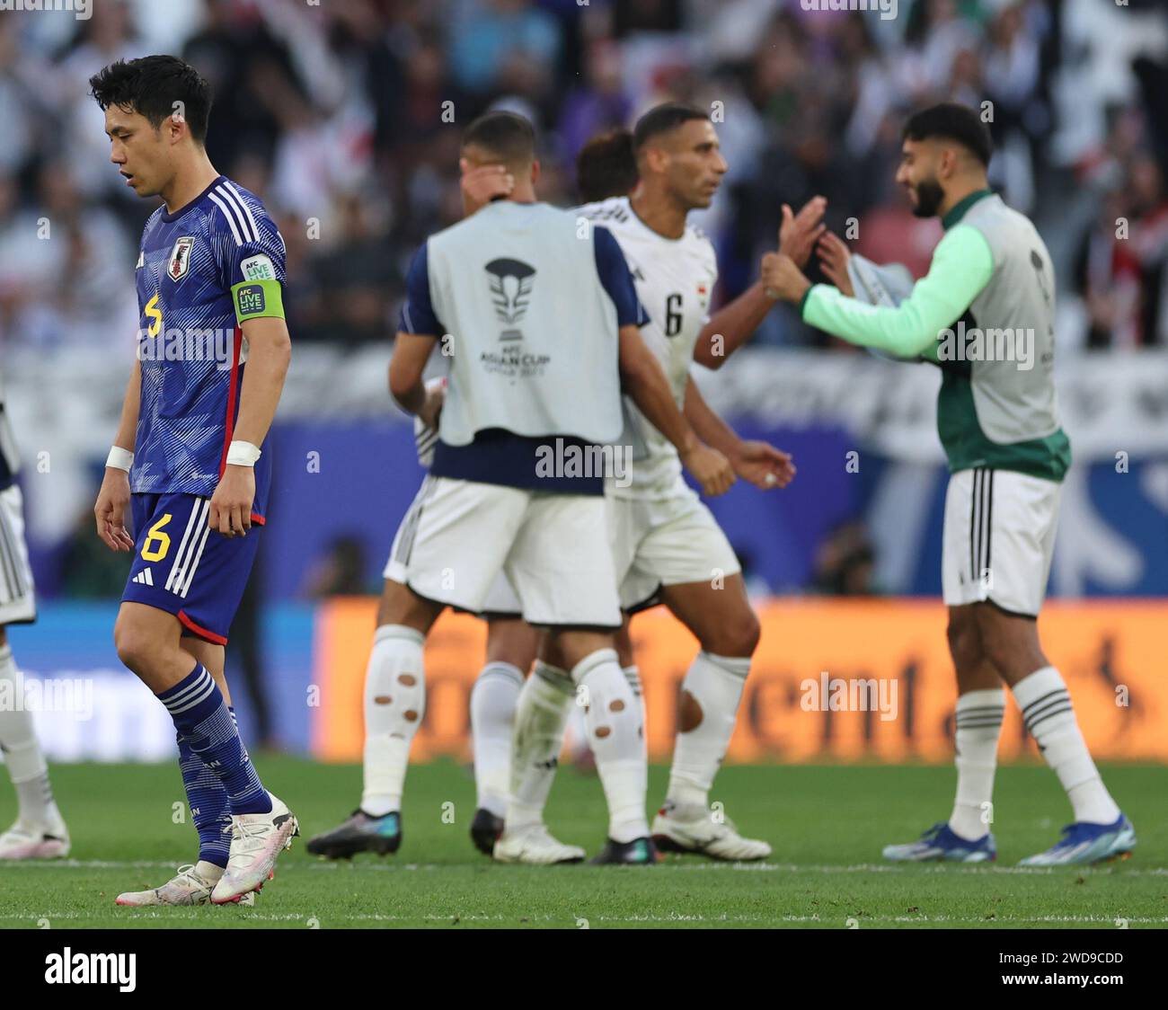 Doha, Qatar. 19th Jan, 2024. Japan's Endo Wataru (L) reacts after the ...