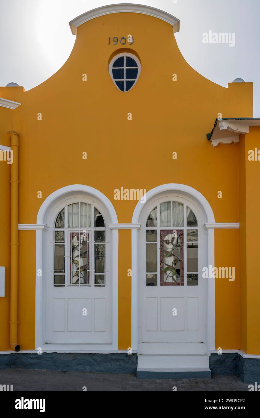 cityscape with entrance doors of picturesque old mellow yellow building ...