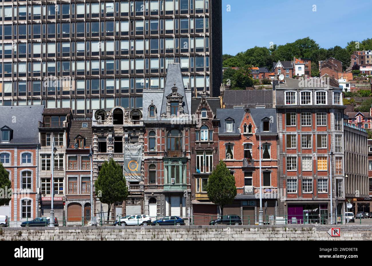 Art Nouveau buildings in front of a skyscraper on the Meuse river, Quai ...