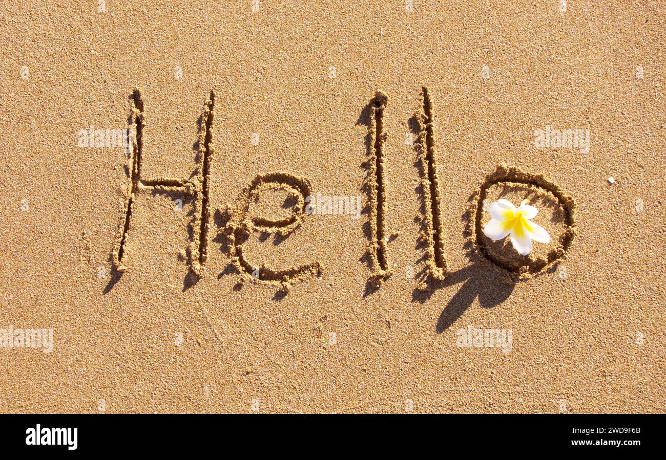 The word Hello written in sand on a beach Stock Photo - Alamy