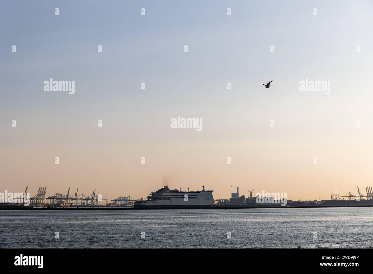 Ships float across the North Sea. Windmills in the background. Sea port ...
