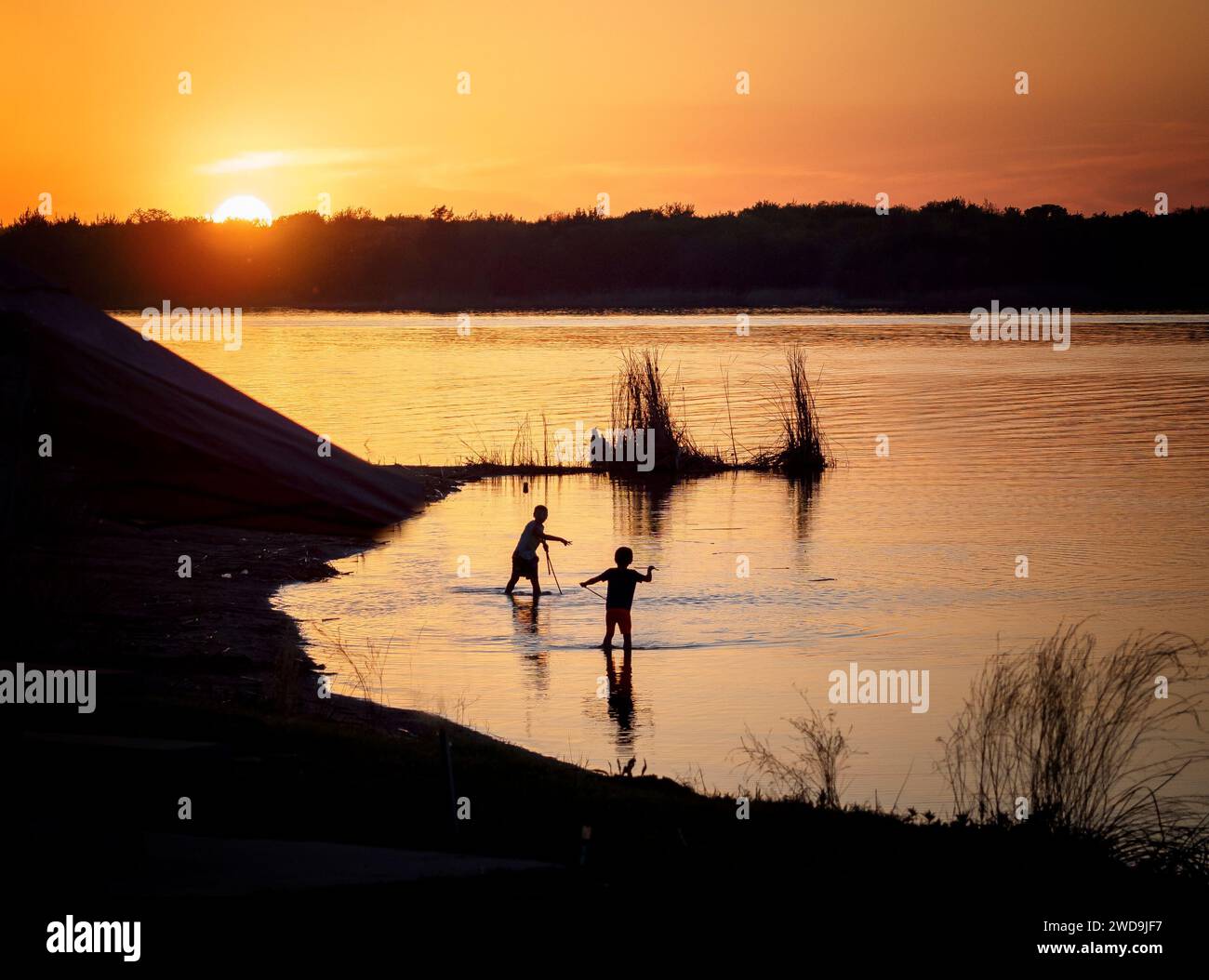In Oklahoma a beautiful lakeside sunset was shining on the water ...