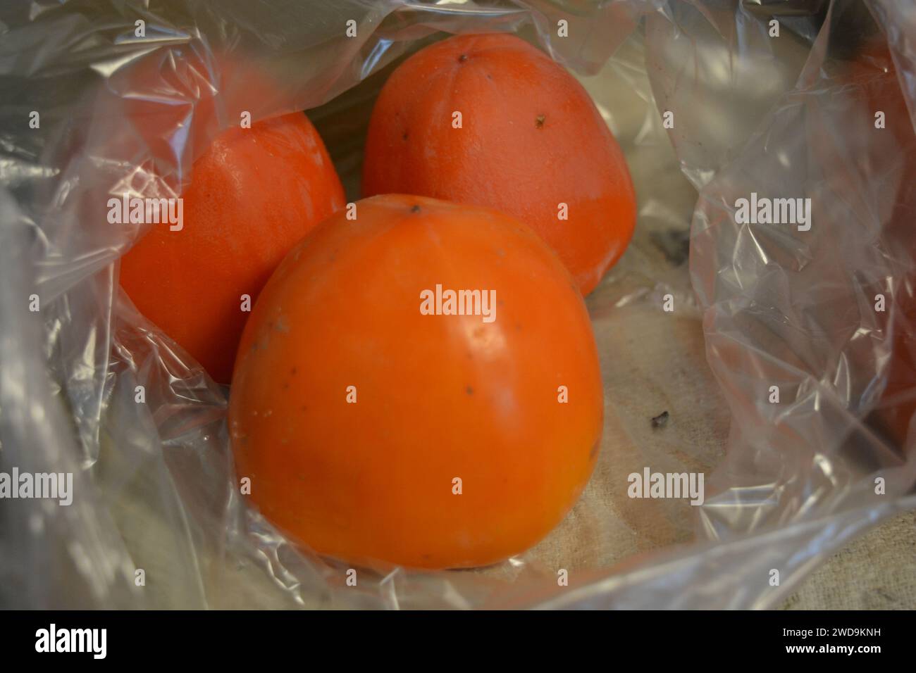 Fresh and healthy products, fresh fruits. Orange, ripe persimmons ...