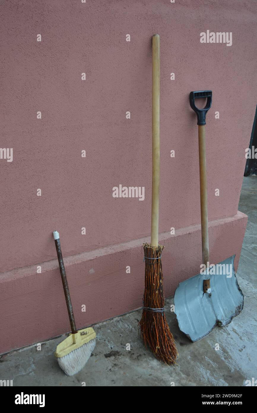 Equipment, household items for housework. An old worn-out broom, a worn ...