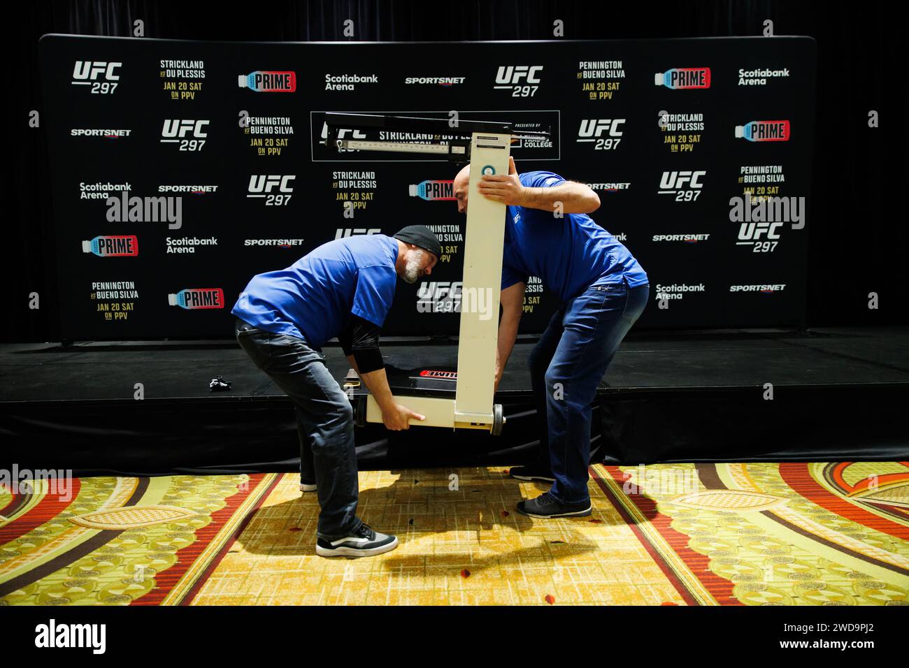 Toronto, Canada. 19th Jan, 2024. Workers move a scale used for UFC ...