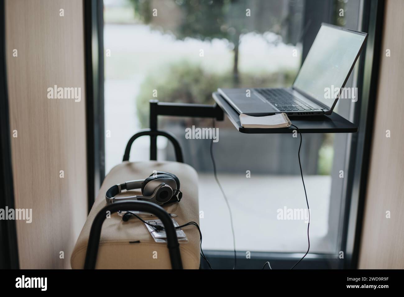 Phone booth setup: seating, small desk, laptop, a mobile workspace ...