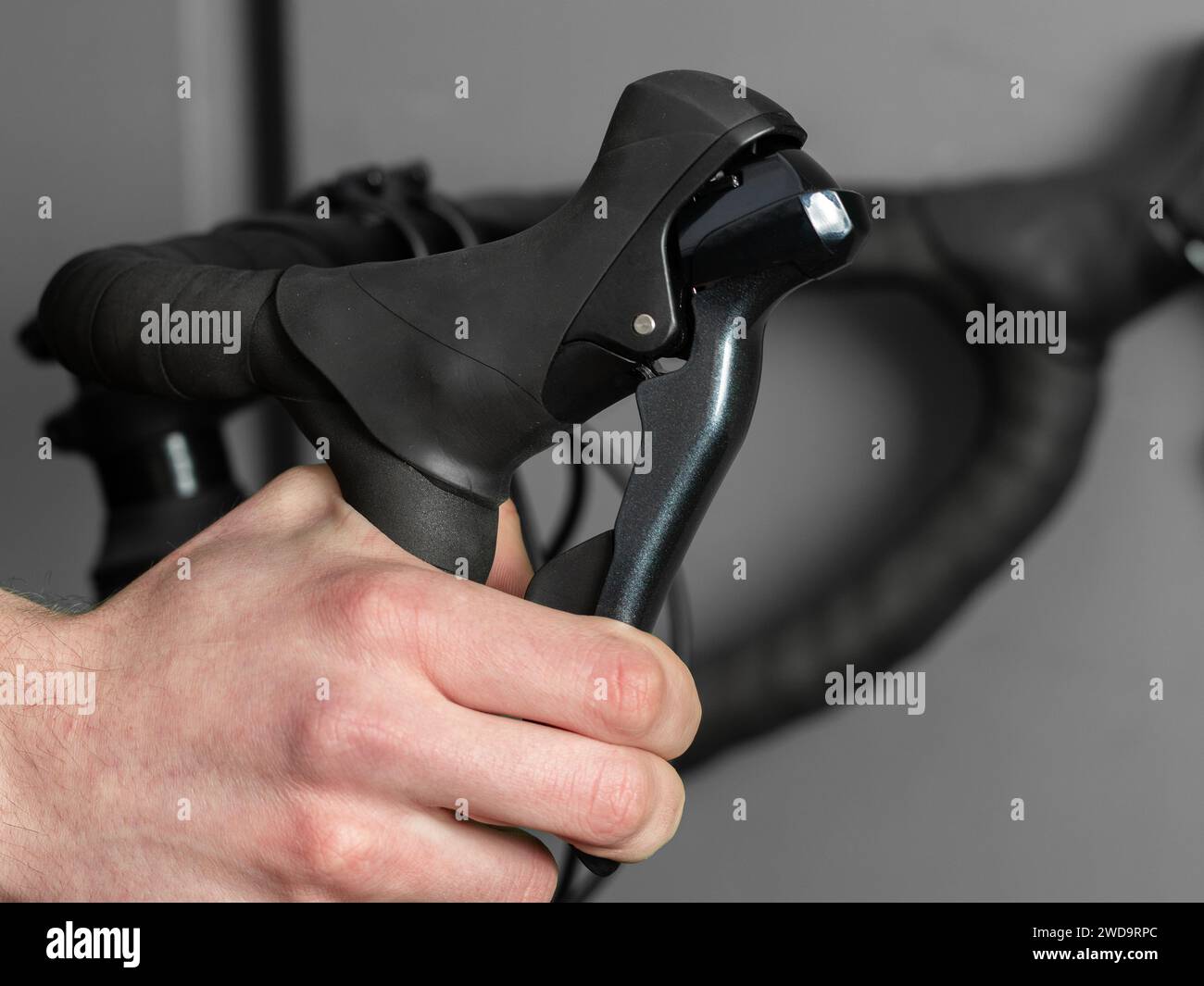 Man presses a brake handle on a road bike. Close up Stock Photo - Alamy