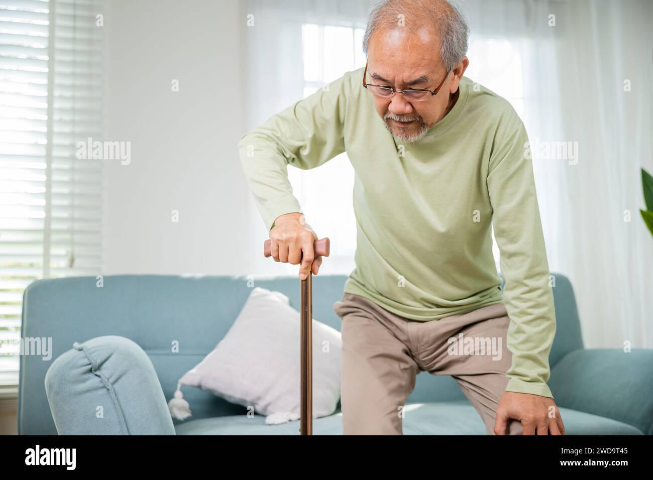 Elderly man suffering from knee pain ache holding handle of cane Stock ...