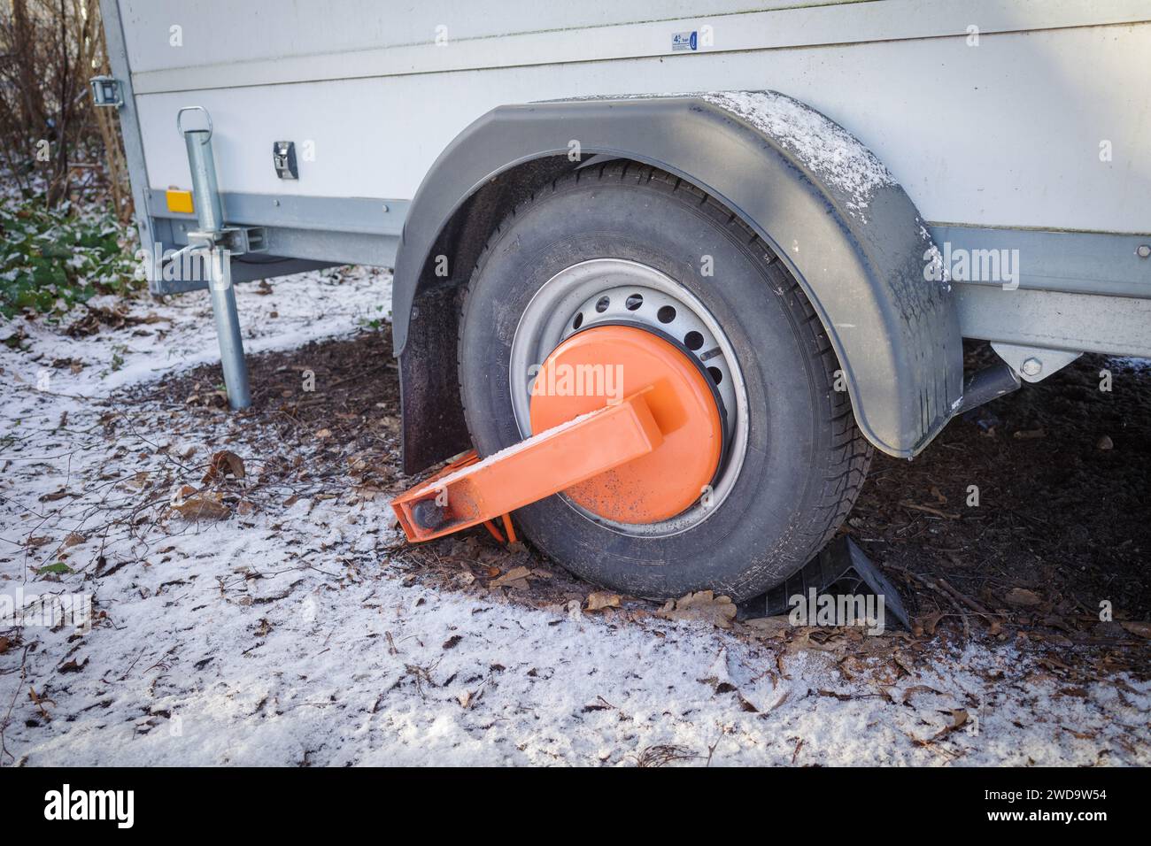 an immobilizer from the public order office is attached to one wheel of ...