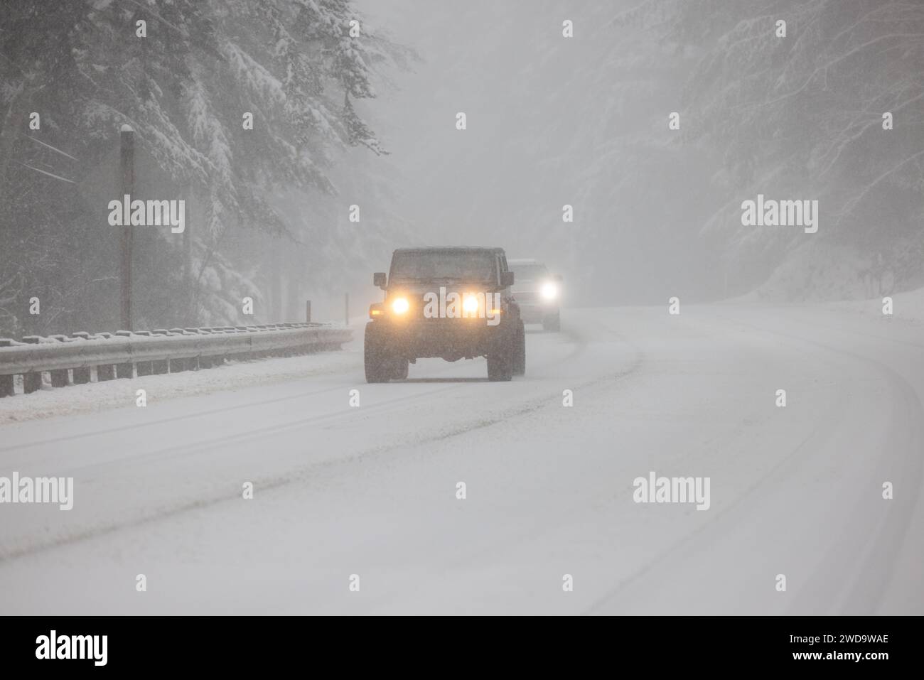 Passenger vehicles driving on snow covered highway 101 in Southern ...