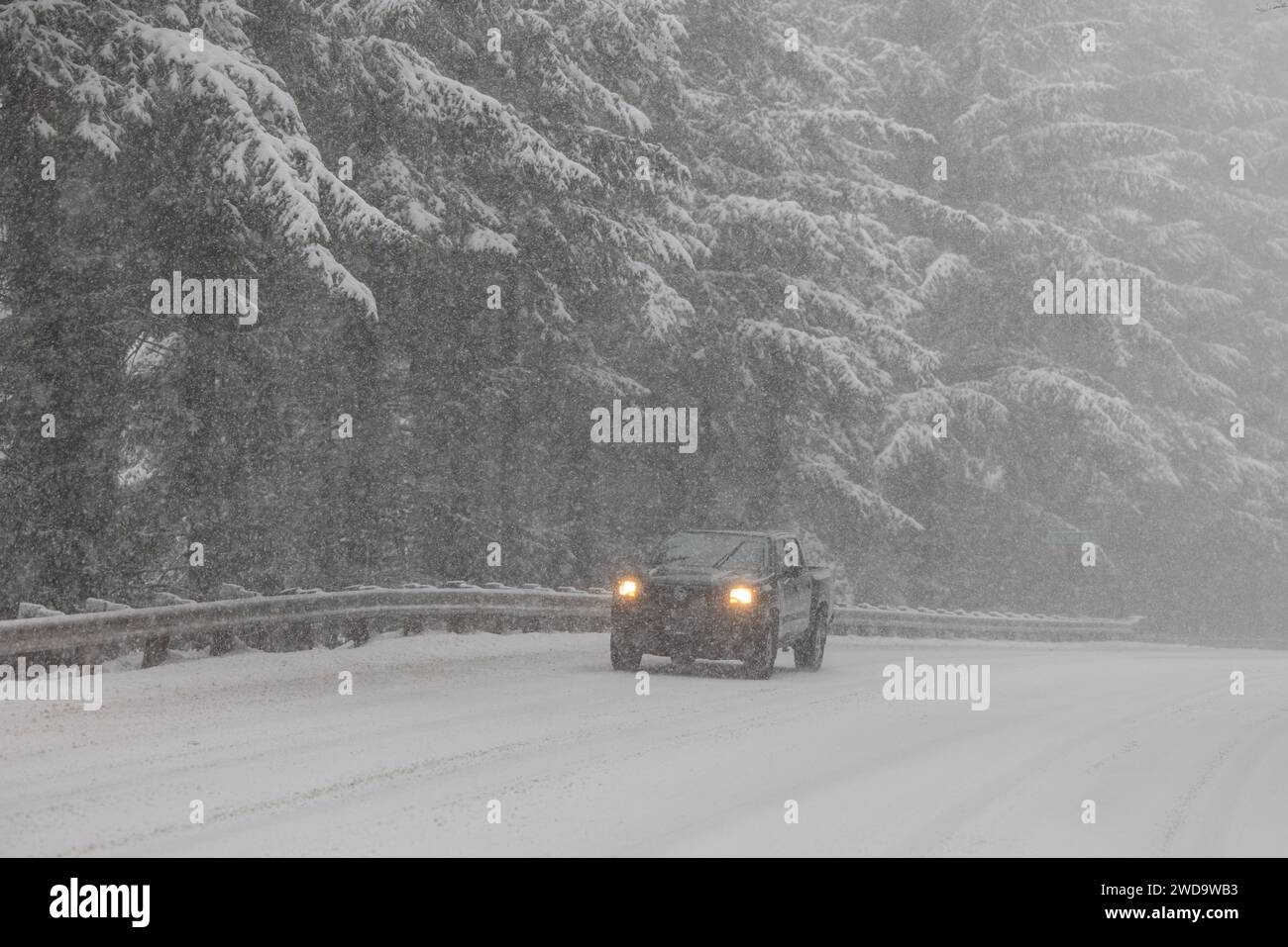 Passenger vehicles driving on snow covered highway 101 in Southern ...