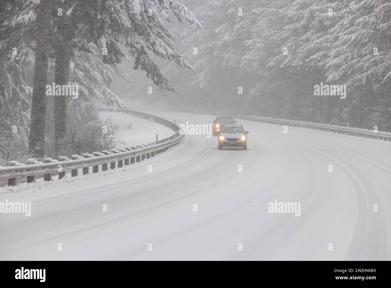 Passenger vehicles driving on snow covered highway 101 in Southern ...