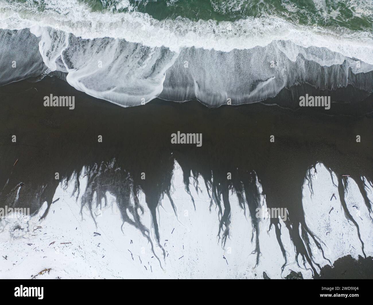 Aerial view of the waves leaving beautiful patterns as it melts the ice ...