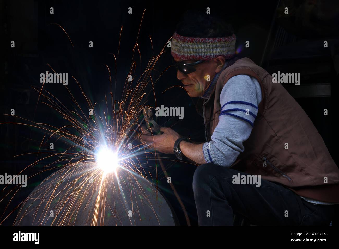 Kathmandu, Nepal. 19th Jan, 2024. A man welds the steel tank inside his ...