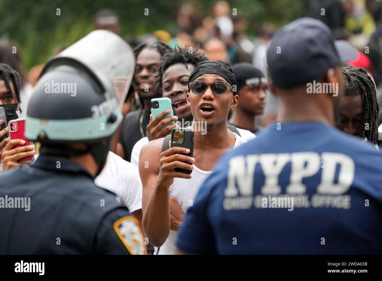 FILE - People video New York City Police Department officers as they ...