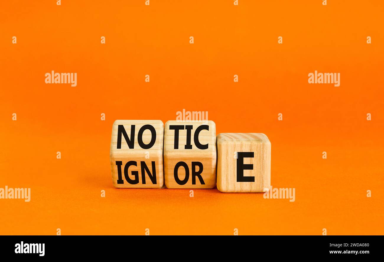 Notice or ignore symbol. Concept word Notice or Ignore on wooden cubes ...