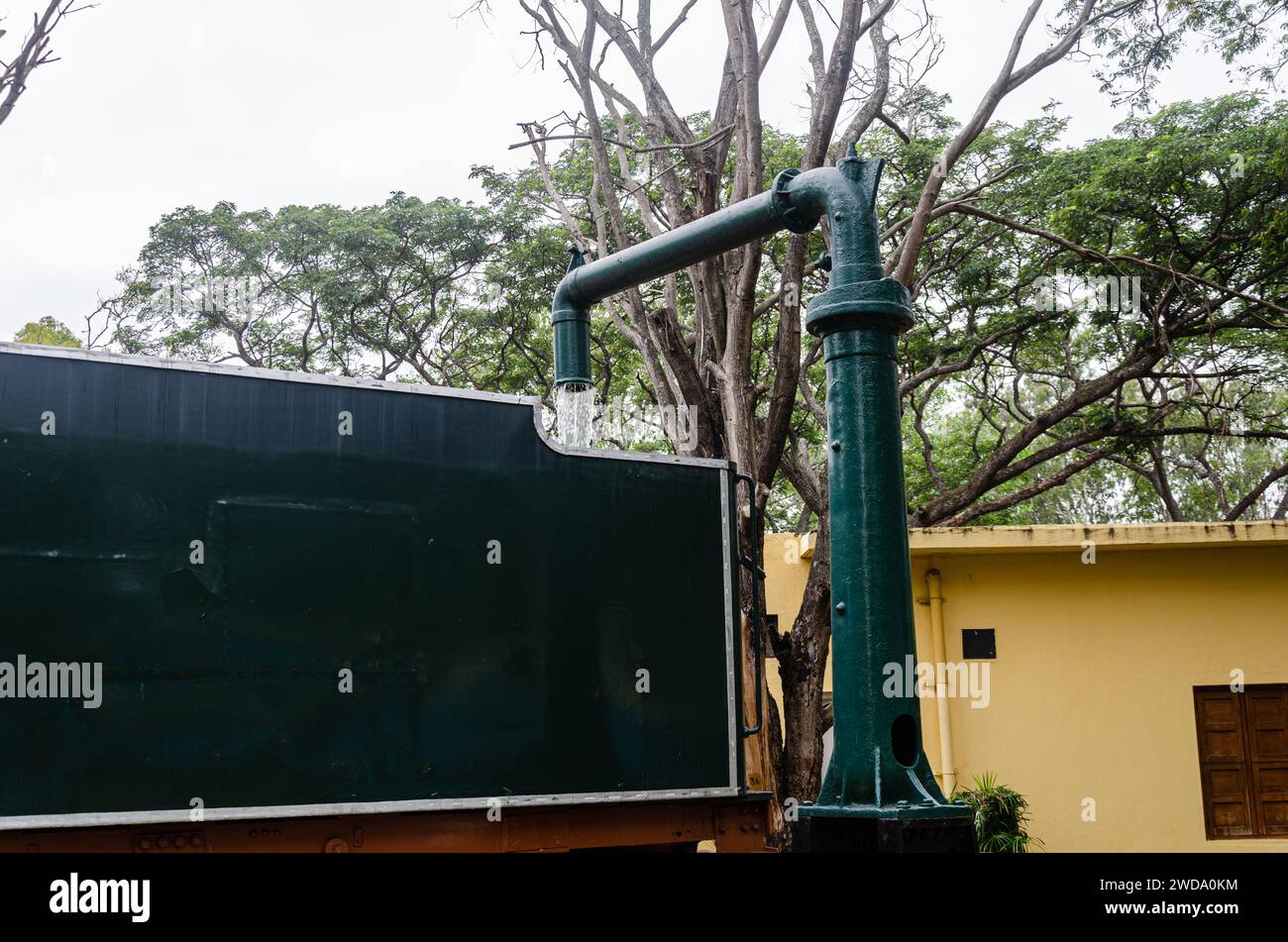 Filling water to an old locomotive steam engine Stock Photo - Alamy
