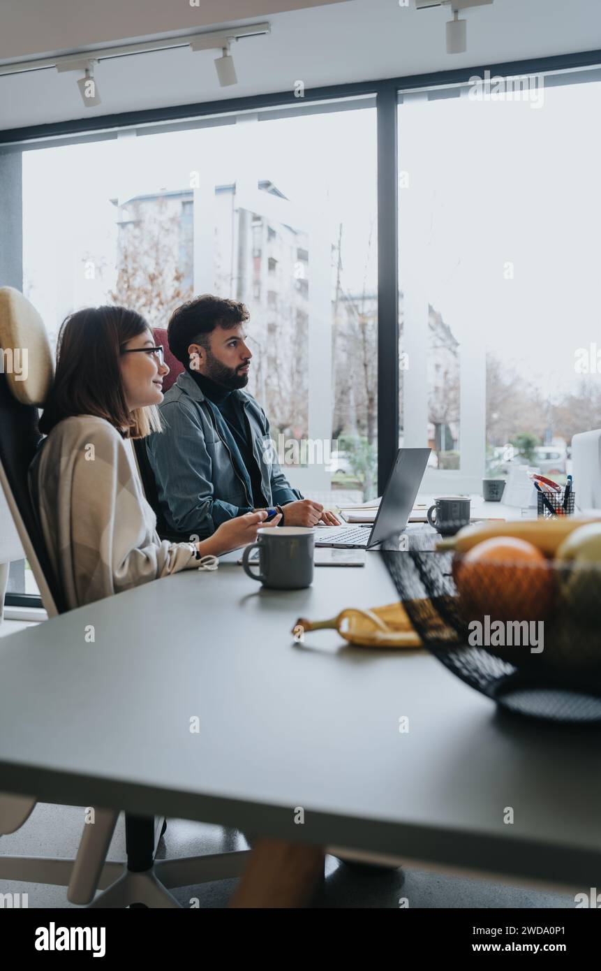 Business entrepreneurs collaborate in an innovative office, discussing ...