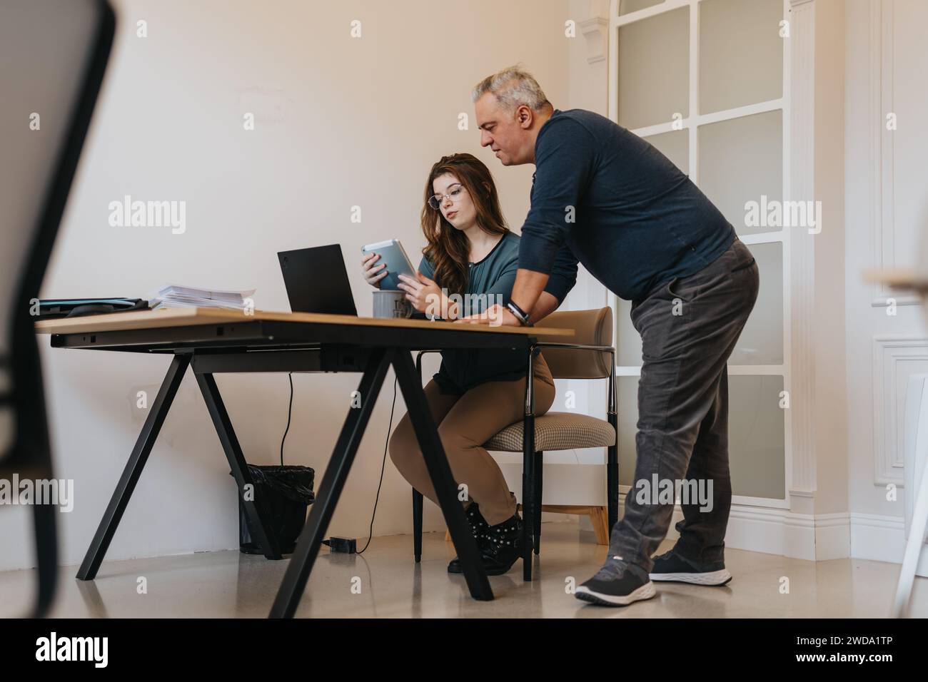 Multi generational team of workers collaborating in innovative office ...