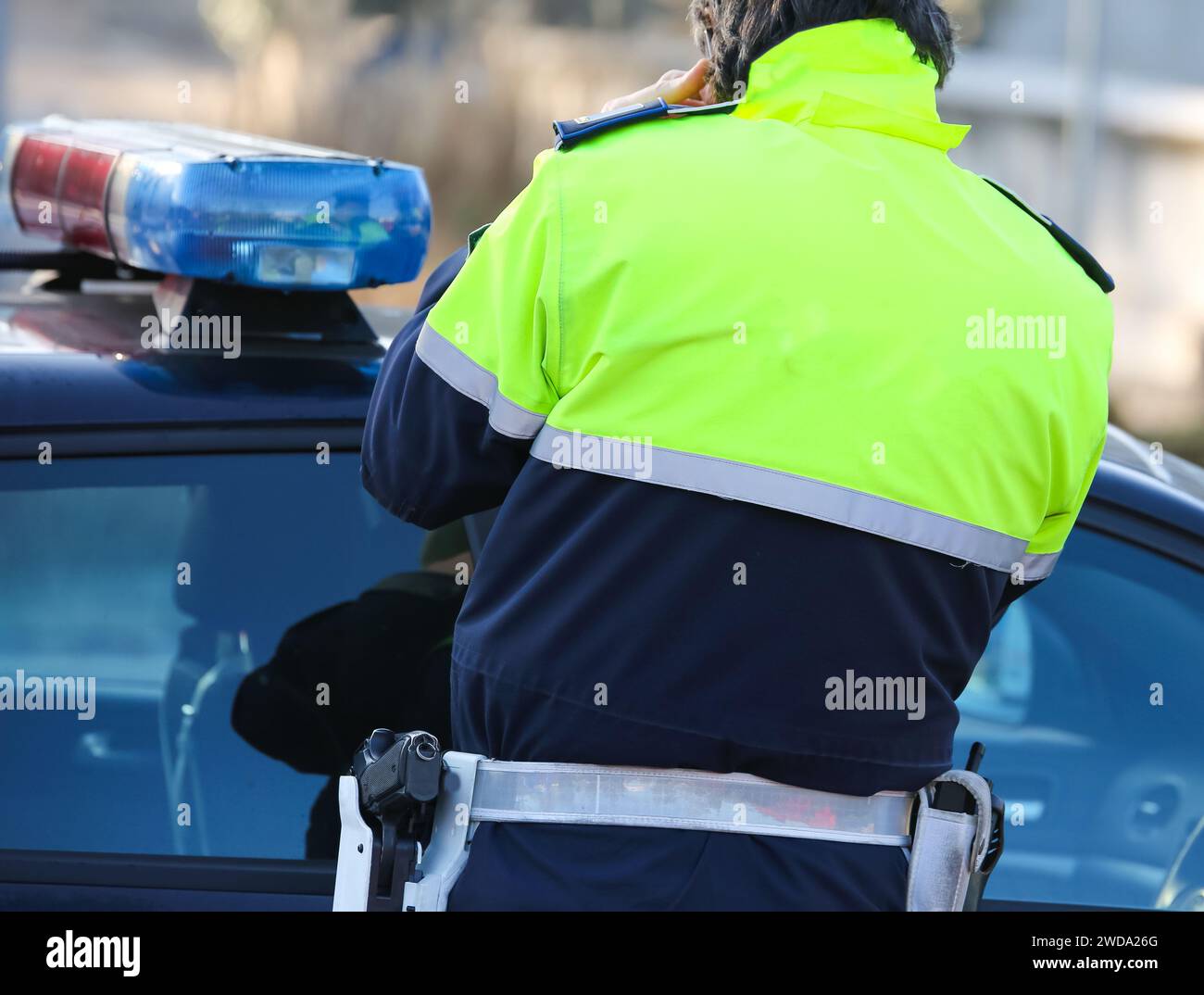 policeman with jacket while talking on the phone with his chief Stock ...