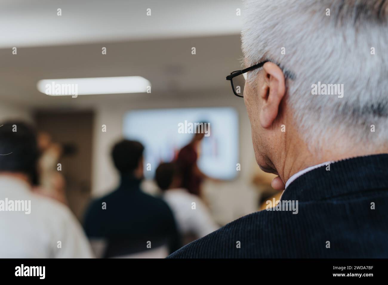 A multi generational group in a productive business meeting, discussing ...
