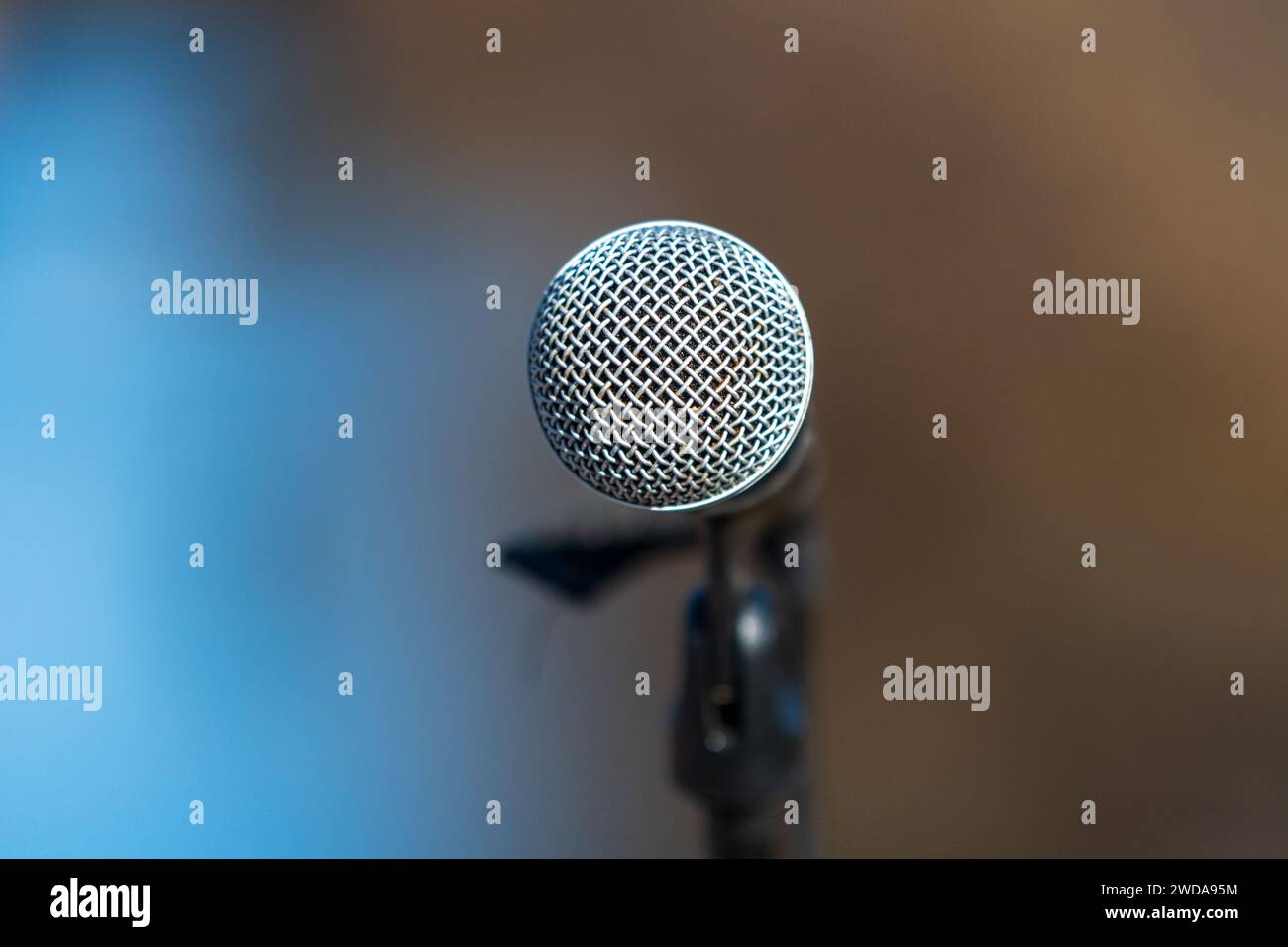 Microphone head, blurry nature, background. Blue and brown. Colors ...