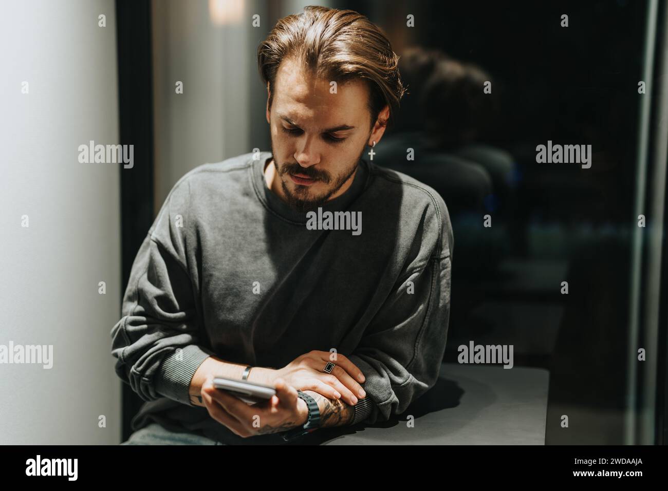 Male person having video call at soundproof phone booth late at night ...