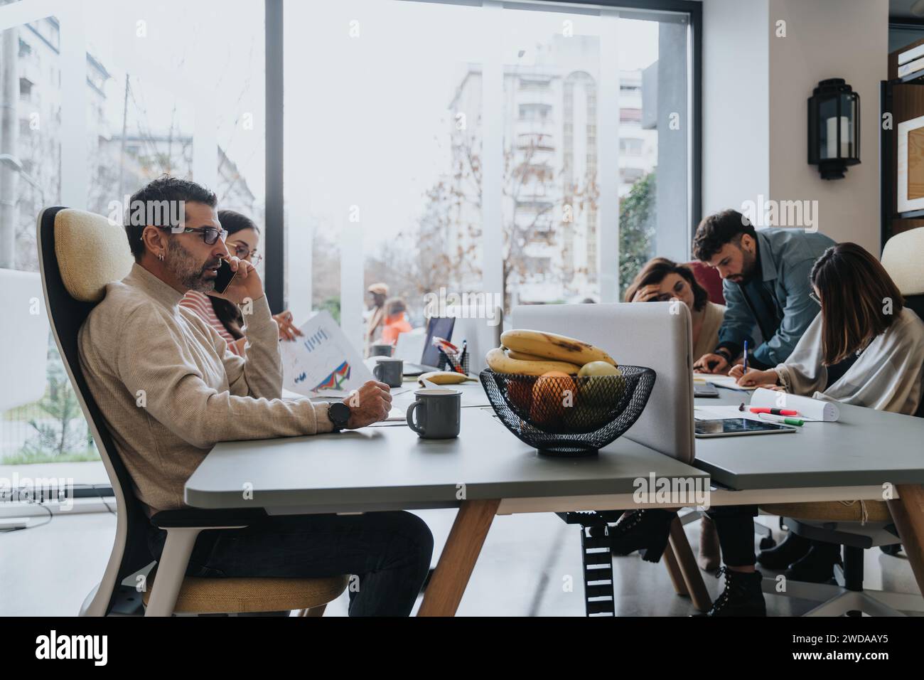 Multi generational coworkers strategizing for business growth ...