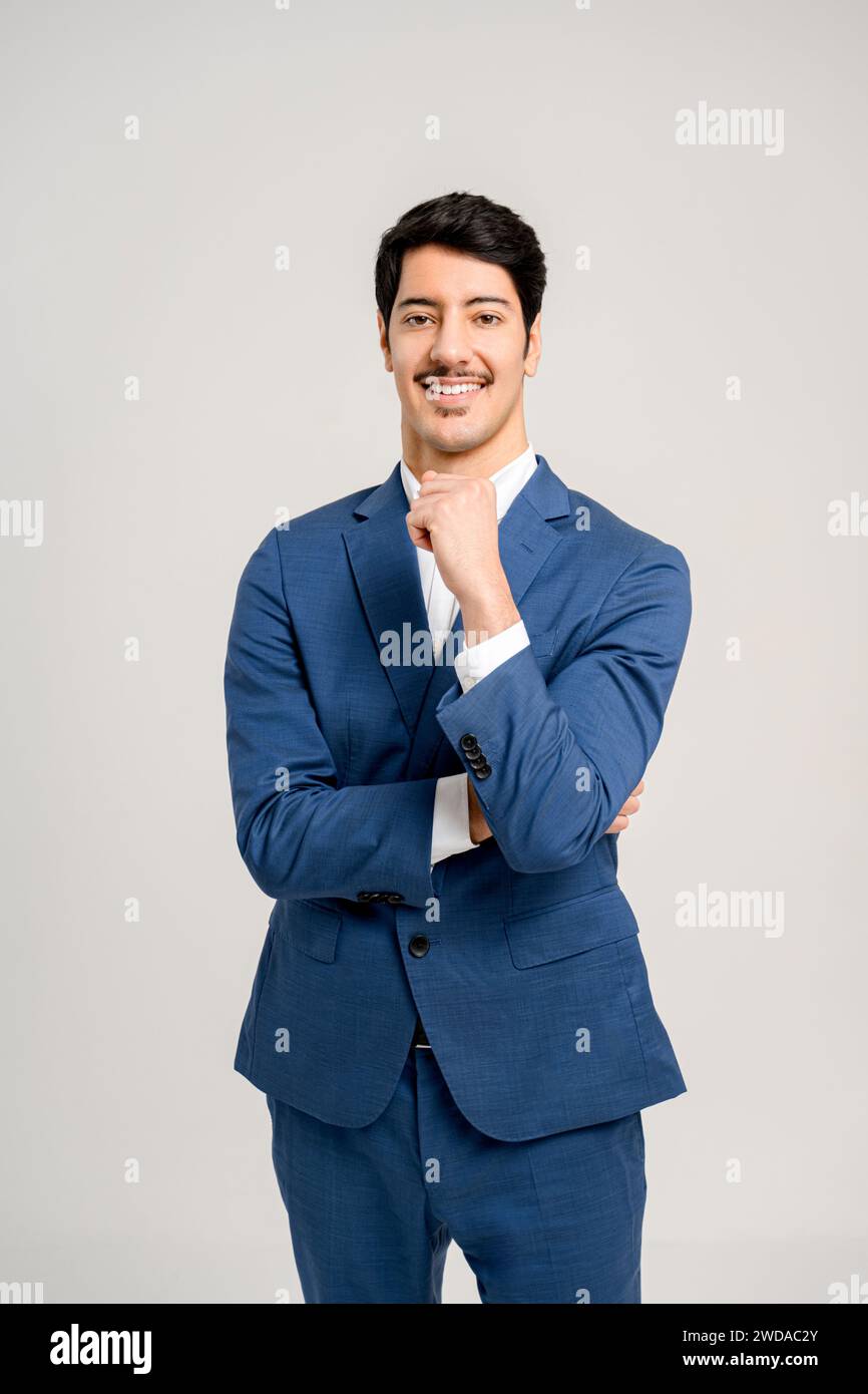 The man poses with a gentle fist under his chin, symbolizing ...