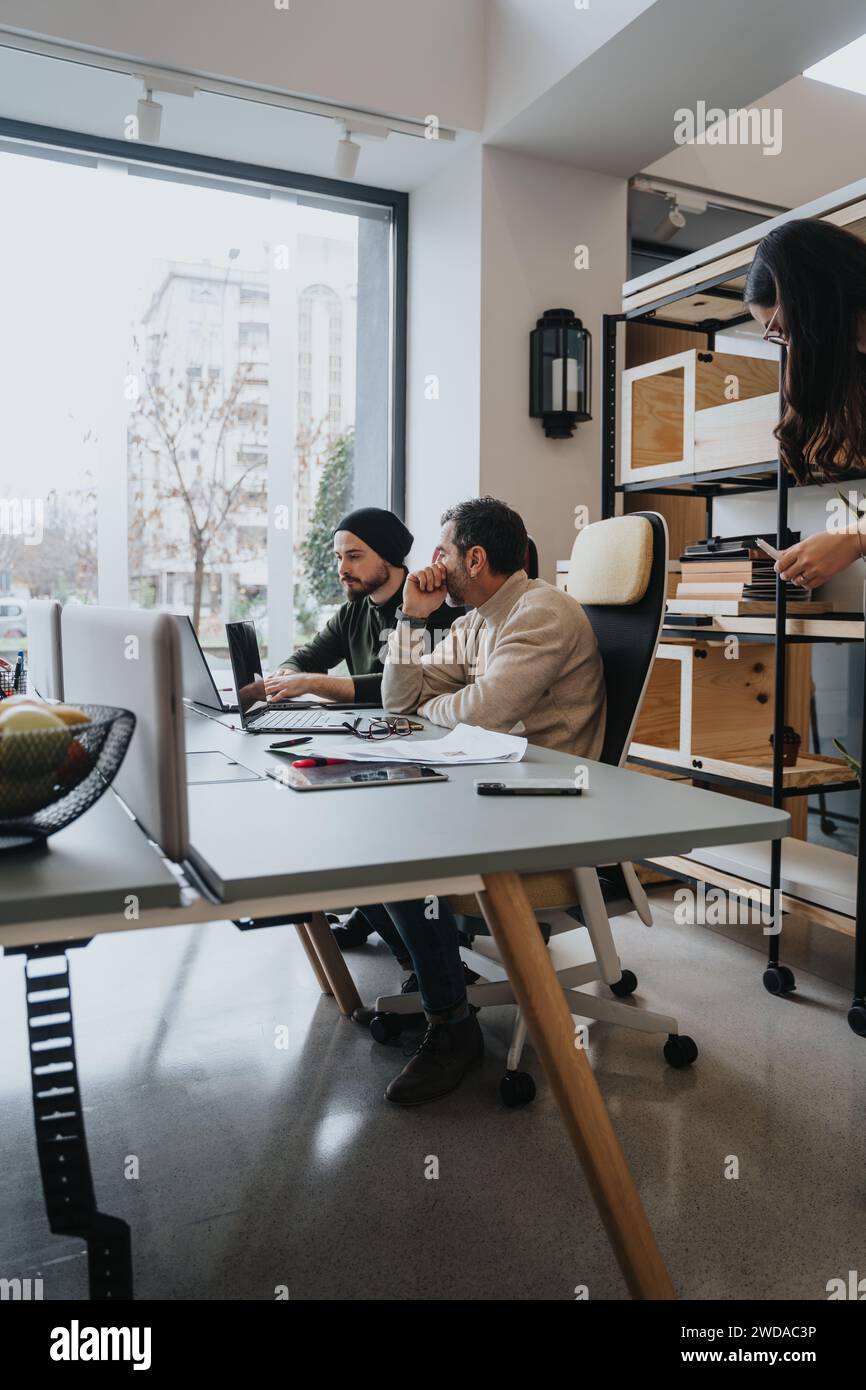 A business team discussing innovative business strategies in a collaborative office environment ...