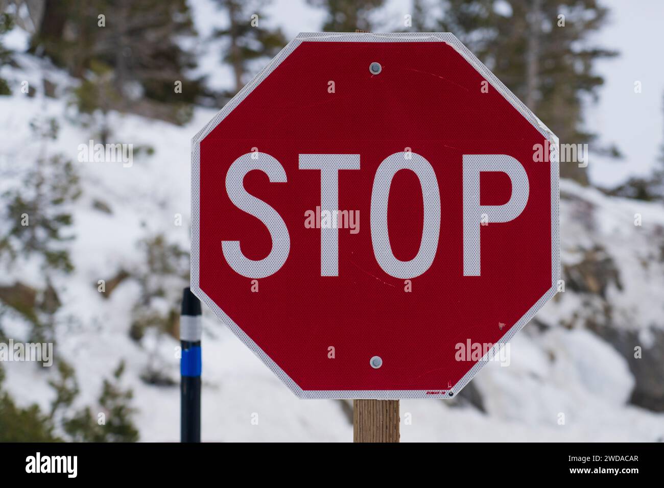 Stop sign with snowy mountain backdrop Stock Photo - Alamy