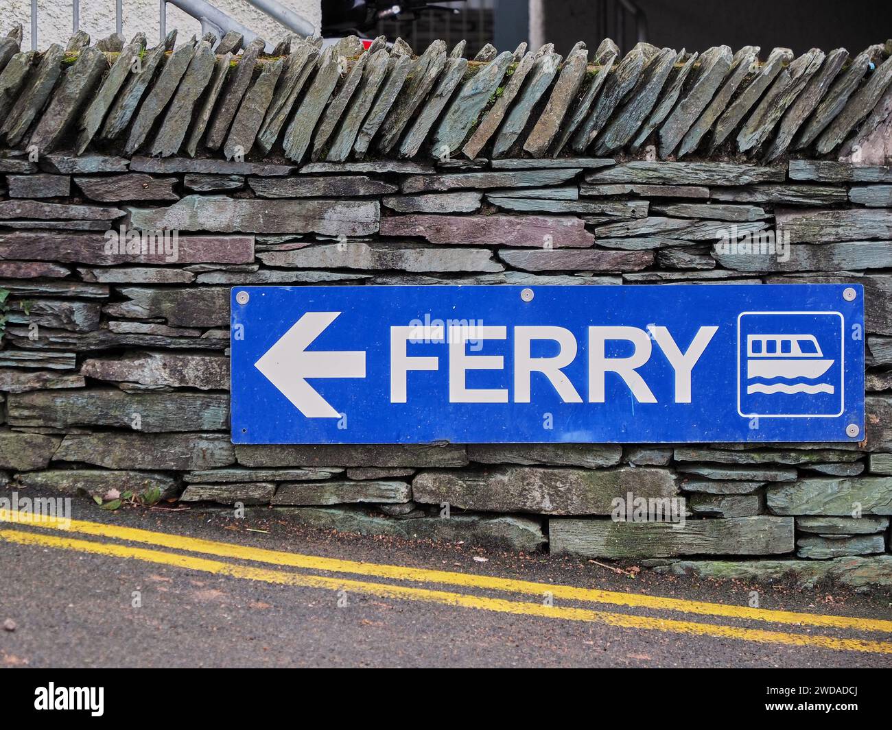 Blue sign indicating the direction to the ferry that links the east and ...