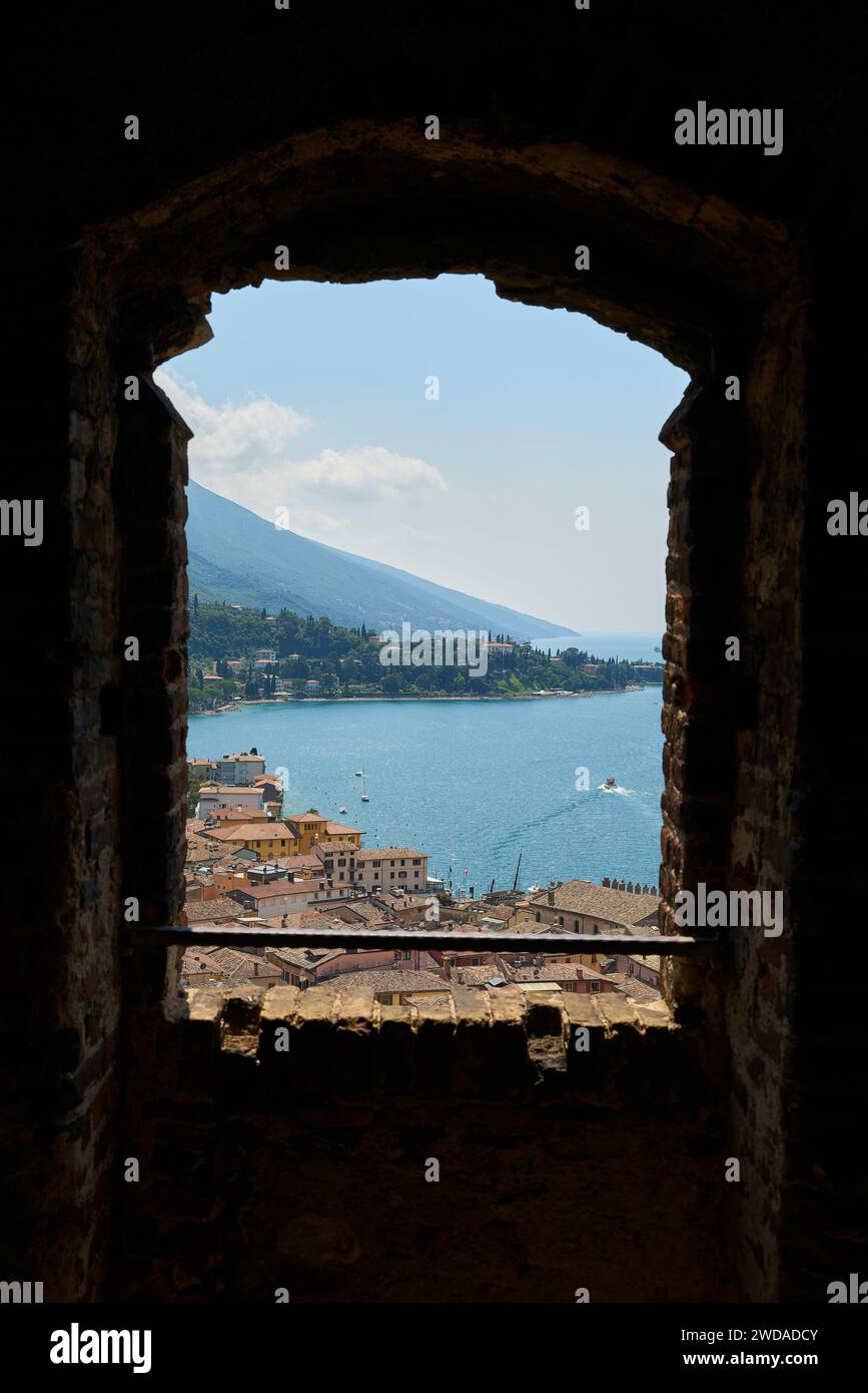 View through a window over the roofs of the old town of Malcesine on ...