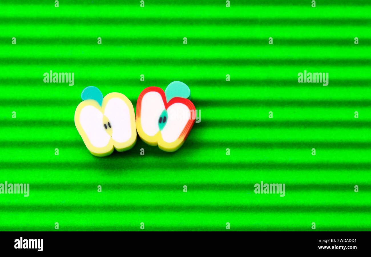 Figures shaped like apples on a green background Stock Photo - Alamy