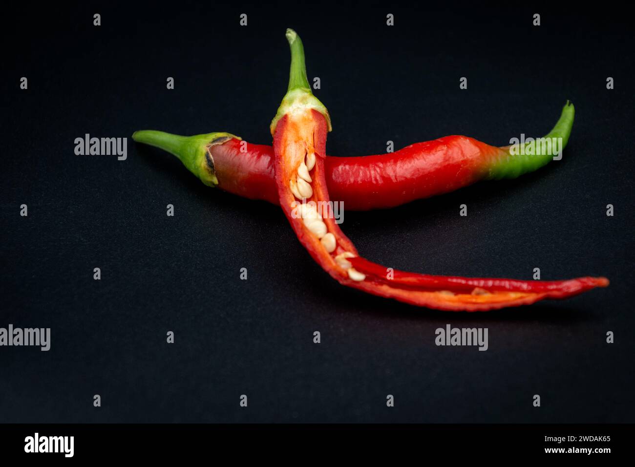 red chili in isolated black background Stock Photo - Alamy