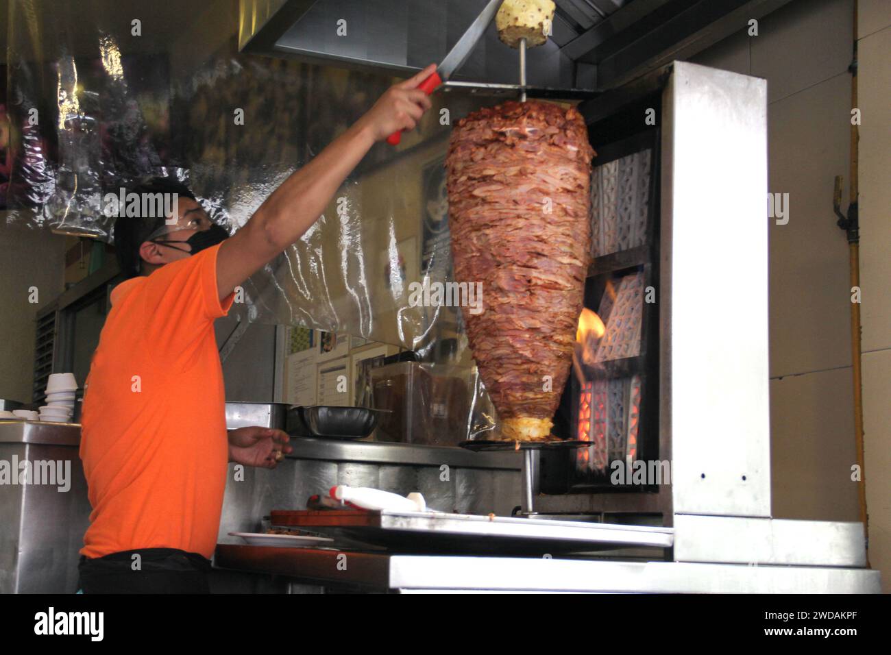 Latino taquero man working with protection mask, typical mexican food ...