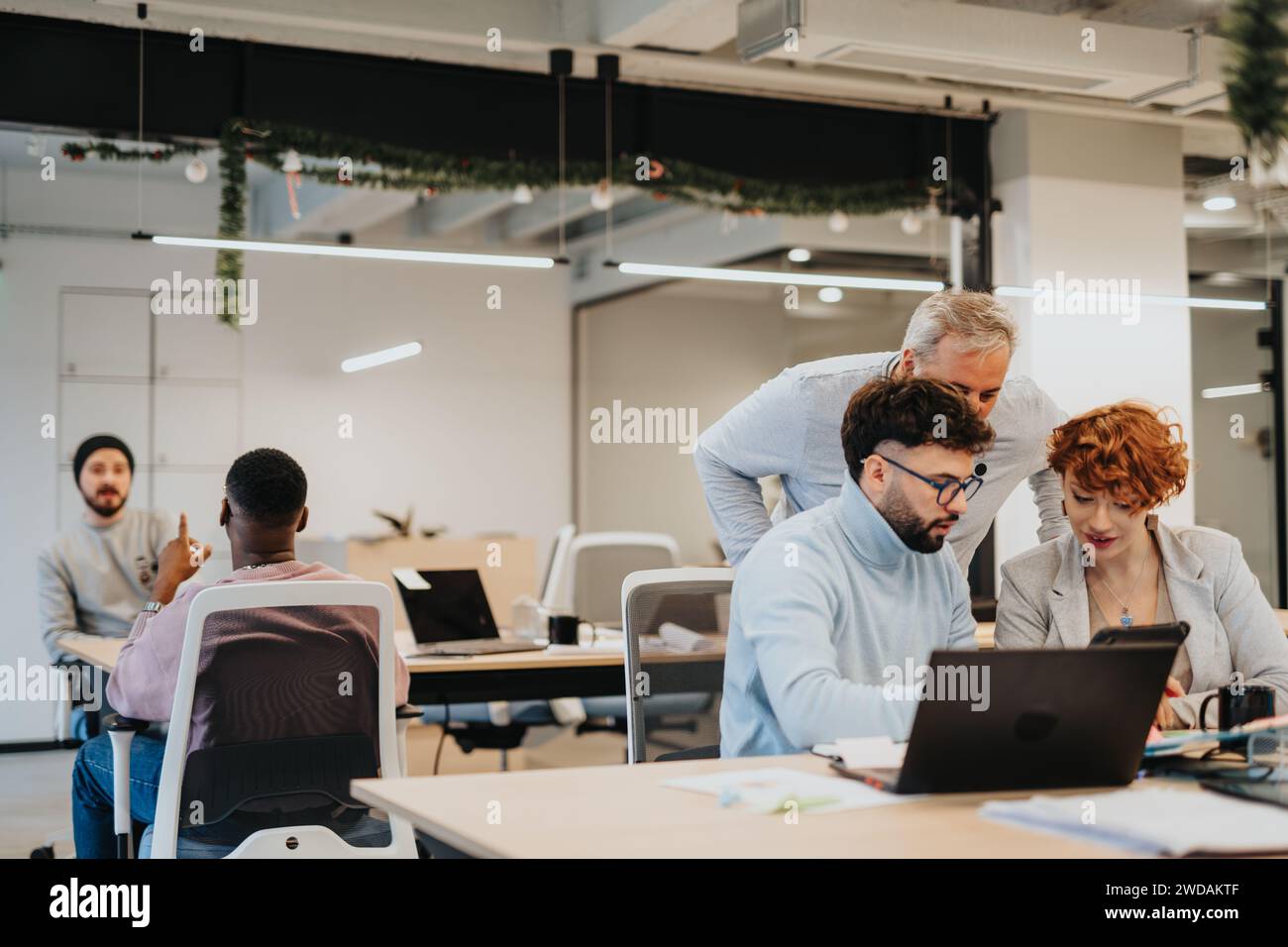 Focused coworkers collaborating in a corporate office, discussing ...