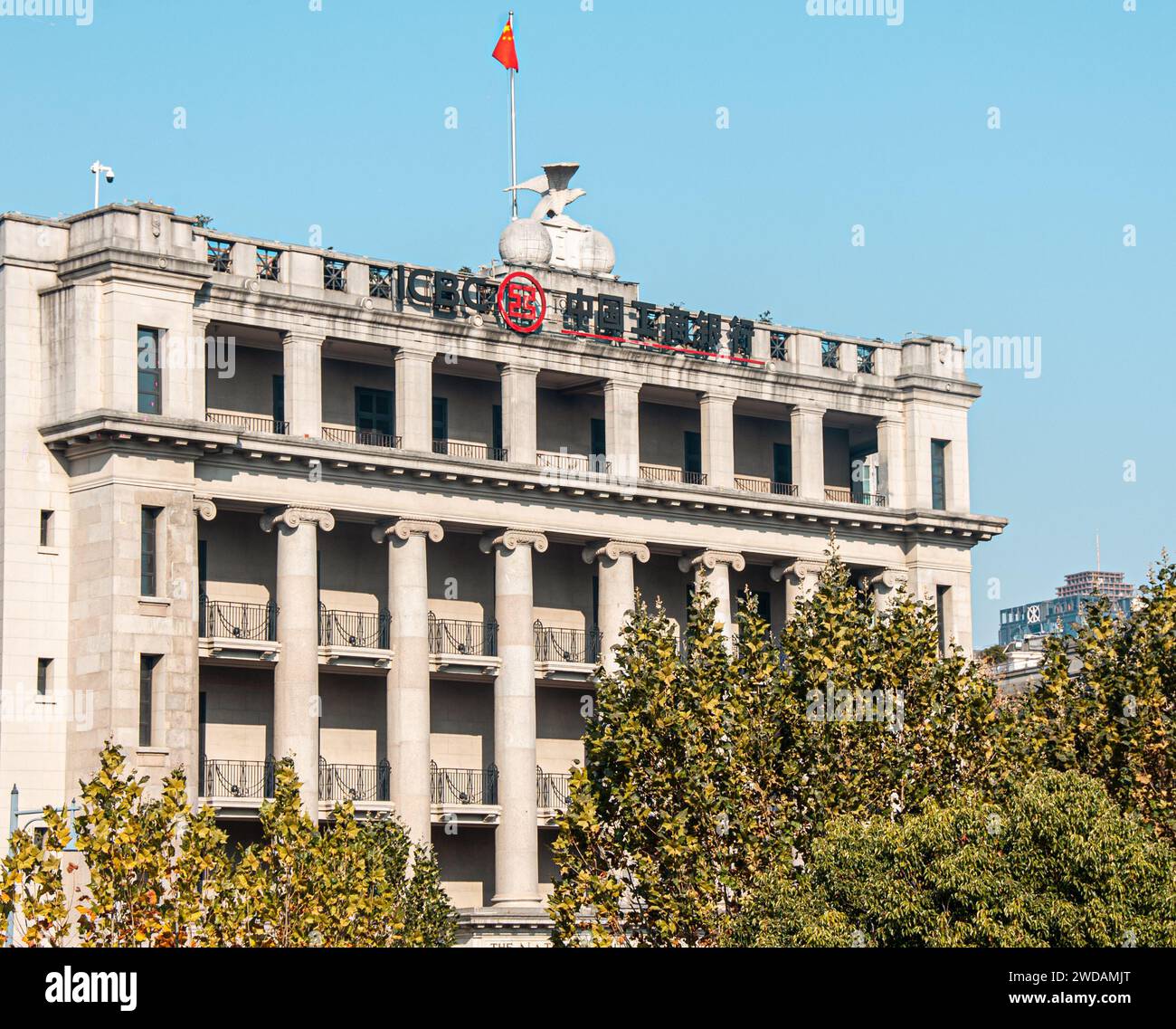 A massive grey building proudly displaying multiple flags atop Stock ...
