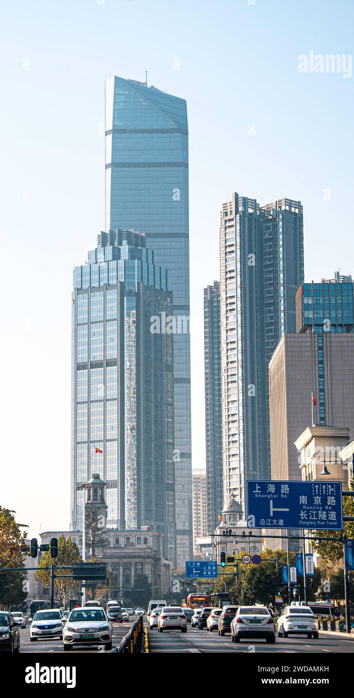 Busy city street in China with cars and traffic, surrounded by towering ...