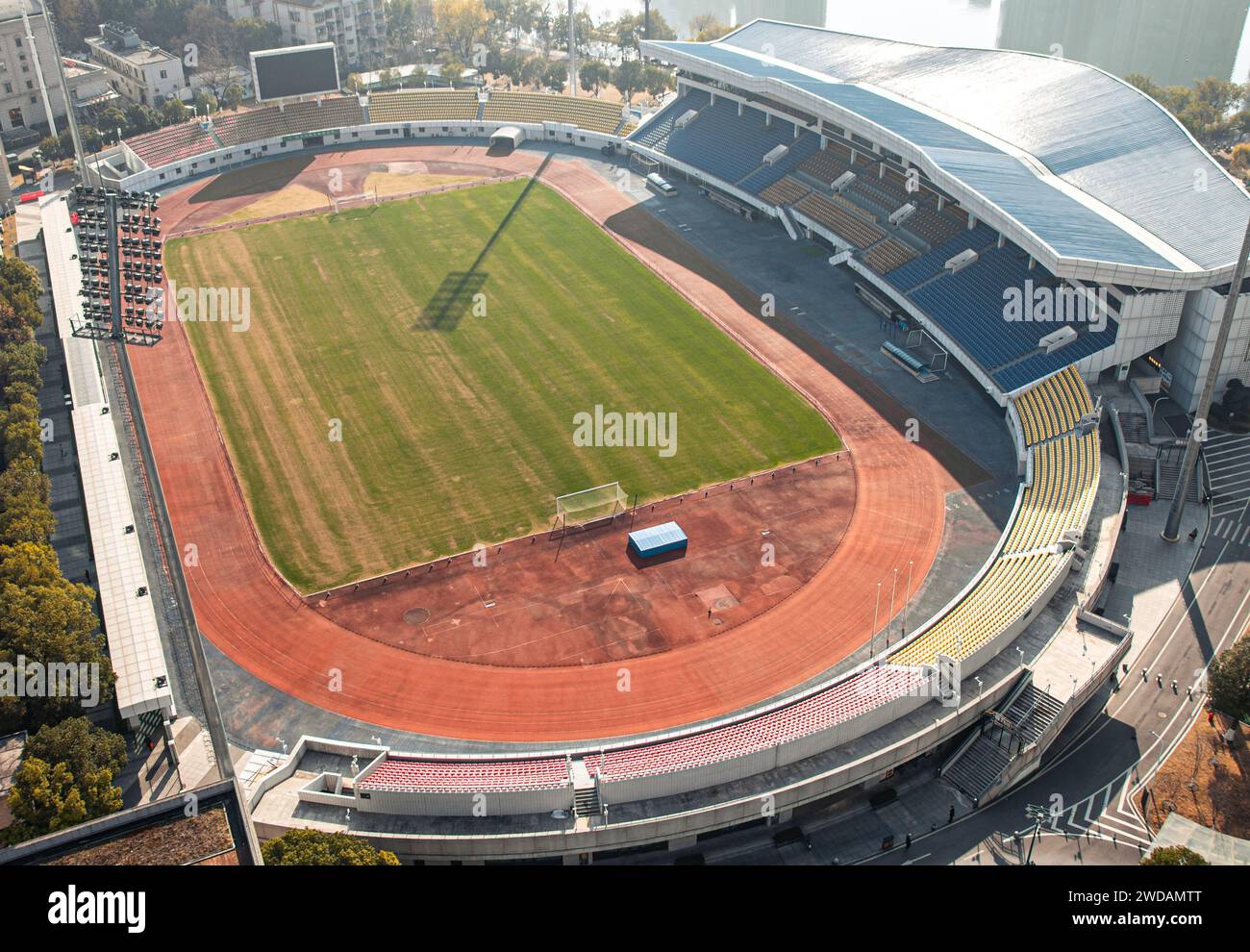 A huge, open sports field with a red runway surrounding a standard ...