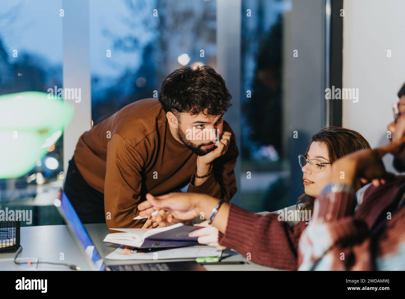 A successful multiethnic startup team focusing on collaborative brainstorming and problem ...