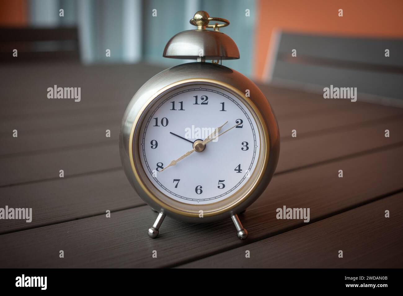 Traditional alarm clock on a table Stock Photo - Alamy