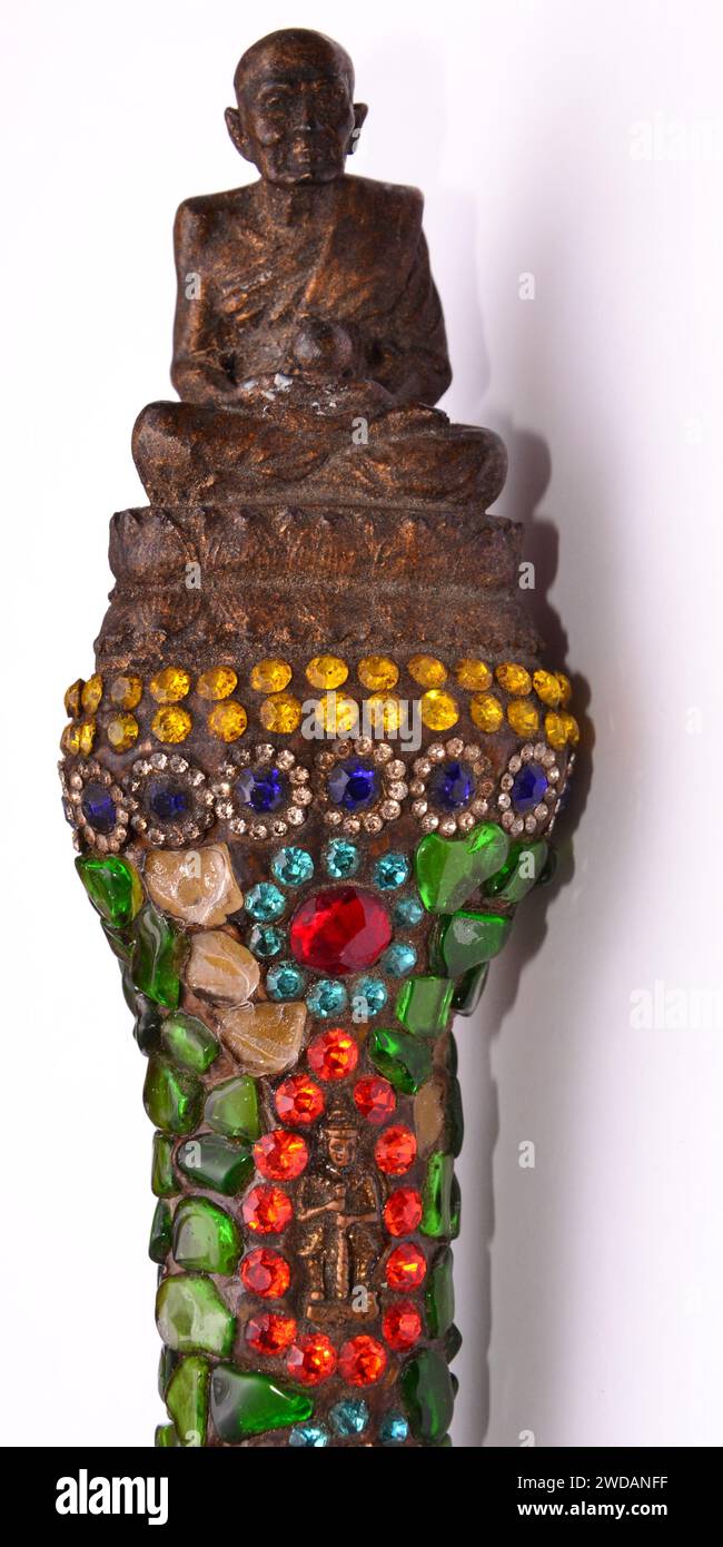 Buddhist religious amulet with metal monk's head and fake jewels on the ...