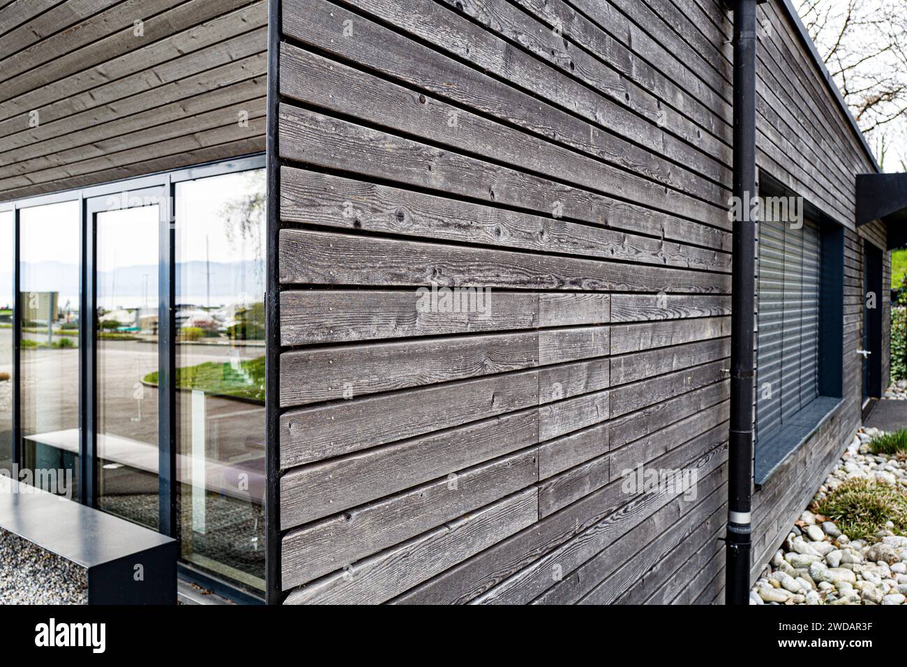 A variety of wooden windows adorn this charming house Stock Photo - Alamy