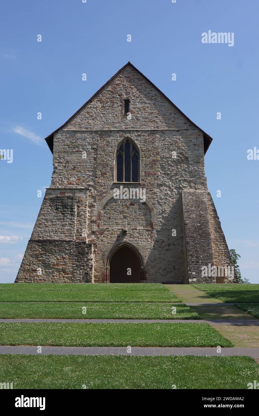 A picturesque building with a prominent steeple and lush green grass in ...