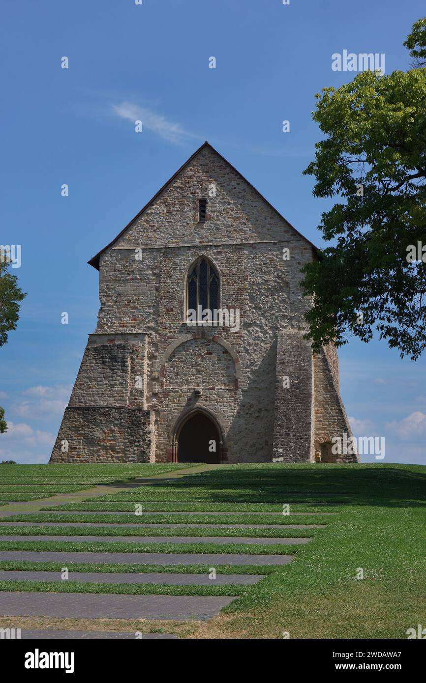 A massive stone structure standing amidst a vast green landscape Stock ...