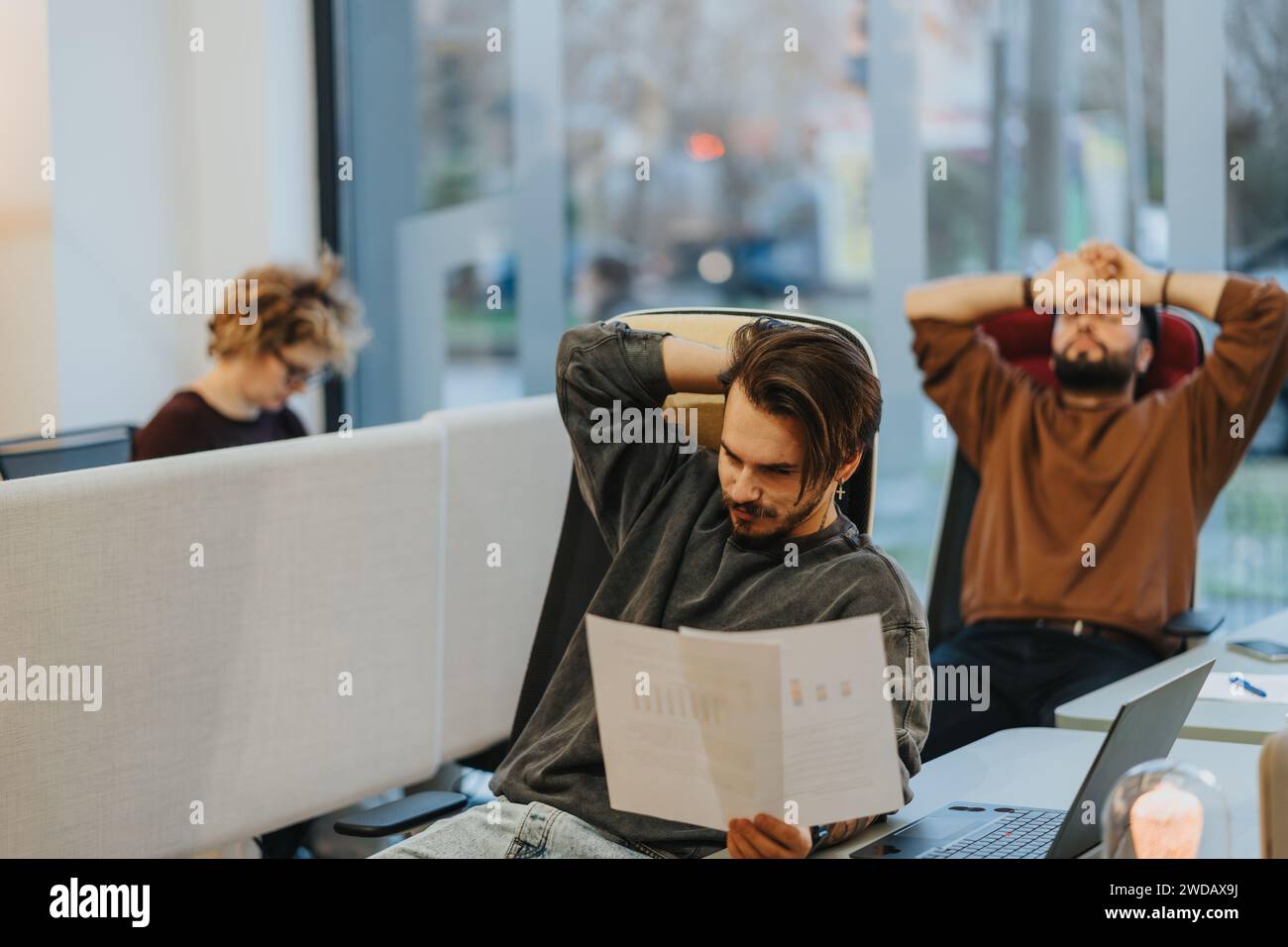 Focused employees working overtime in office, stressed and exhausted ...