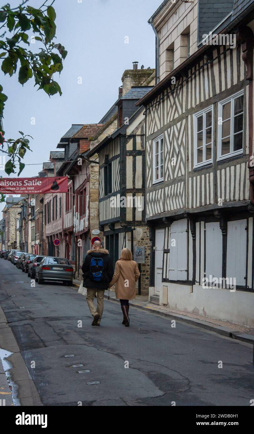 Street view of ancient buildings with a couple holding hands walking ...