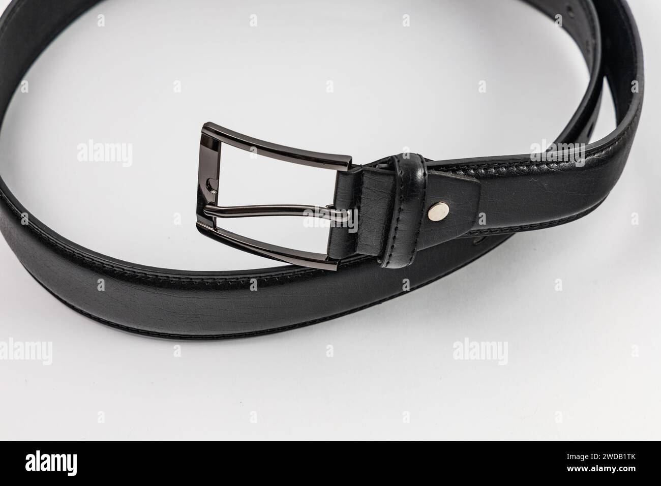 Long and wide black leather belt with few small holes and metallic big ...